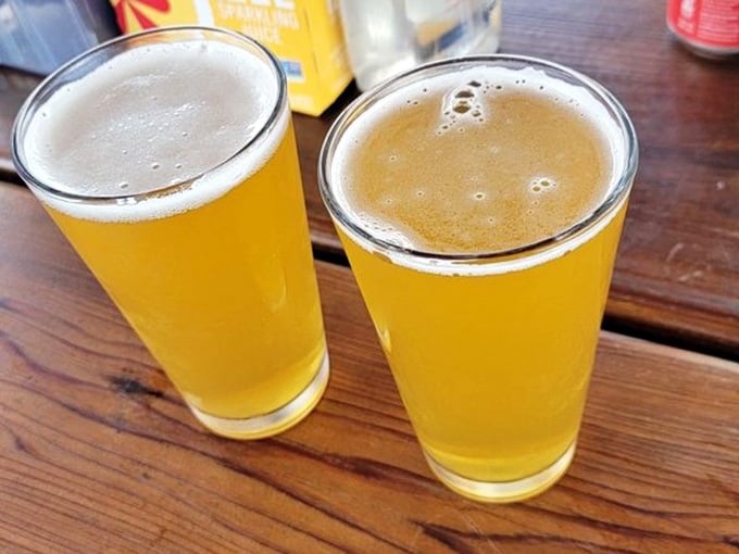 Two cold pints on a wooden table with the harbor nearby. The only thing missing is you sitting there right now.