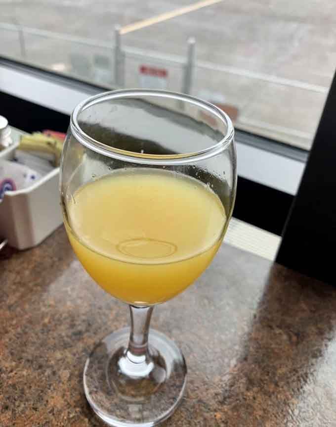 A mimosa that catches the light perfectly, because brunch without bubbles is just a sad breakfast meeting.