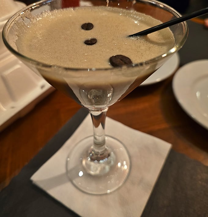 An espresso martini with three coffee beans floating on top, the perfect punctuation mark on a magnificent meal.
