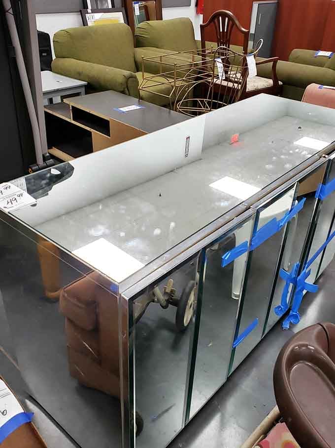 Sofas, mirrors, and a mirrored bar cabinet, because apparently someone out there was living their best 1970s lounge life.