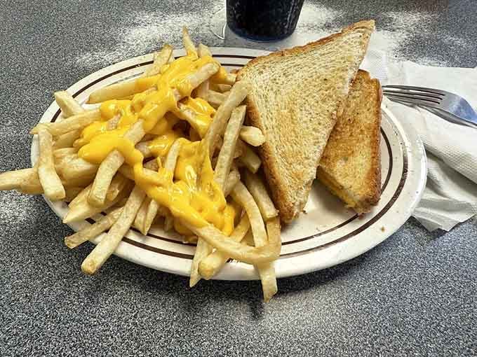 Golden toast, melted cheese, and a mountain of cheese fries. Simple food done with complete conviction.