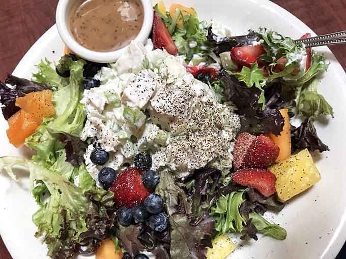 Fresh greens, blueberries, strawberries, and chicken salad. Proof that eating well and eating beautifully are the same thing here.