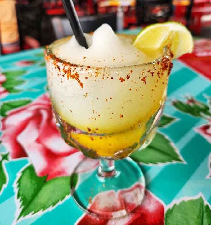 That chili-rimmed frozen margarita is basically a vacation in a glass, no boarding pass required.