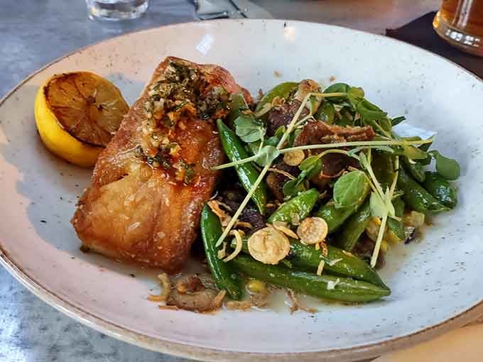 Local fish, beautifully seared, surrounded by fresh greens and a squeeze of lemon that just makes everything right.