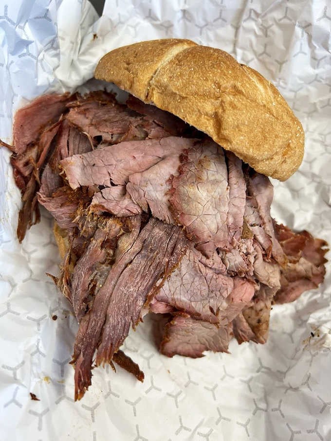 Sliced pit beef tumbling out of a roll, the kind of sandwich that makes you forget your own name.