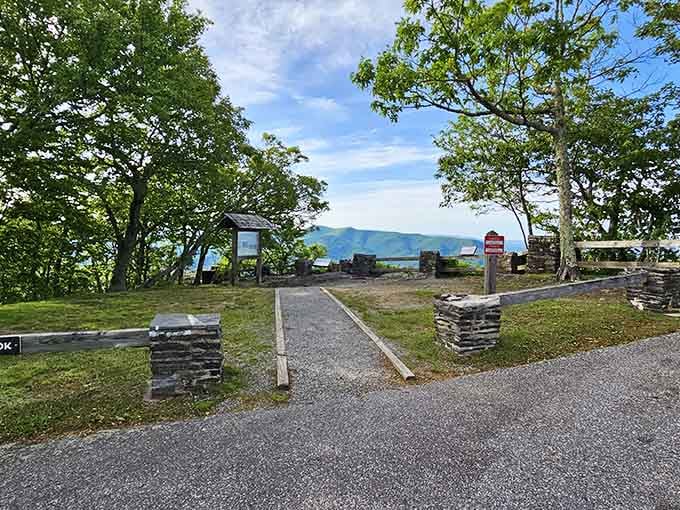 Stone pillars, a gravel path, and mountains peeking through the trees like they've been waiting for you.