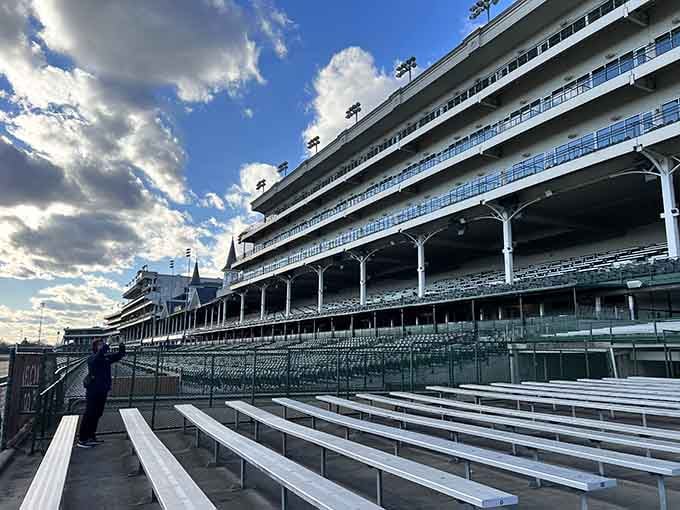 Empty grandstand seats stretching toward those famous twin spires carry a quiet electricity that no crowd could ever fully explain.