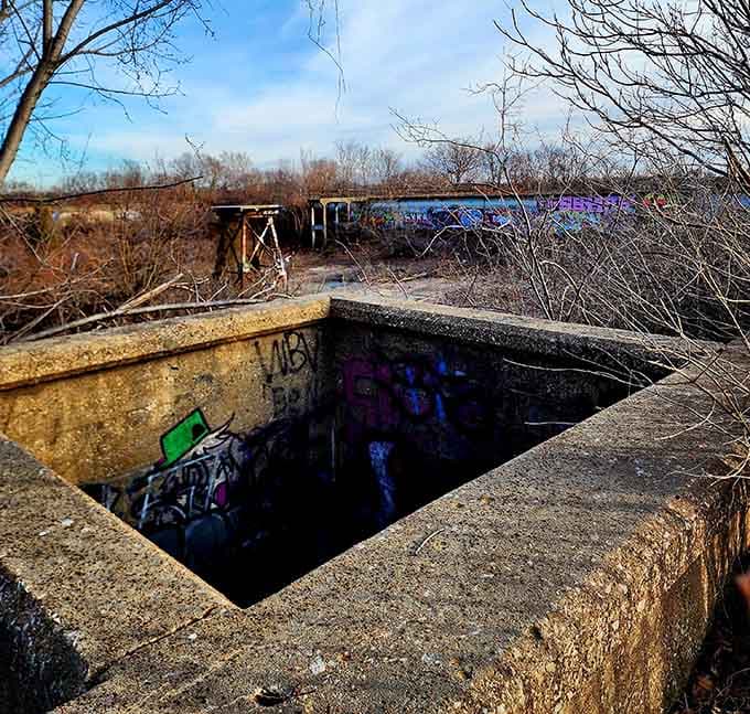 Dark chambers beneath the surface hint at the reservoir's original purpose, now transformed into shadowy art spaces.