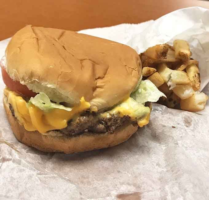 A cheeseburger with lettuce, tomato, and melted cheese, paired with hand-cut fries. Sometimes the classics just refuse to be improved upon.