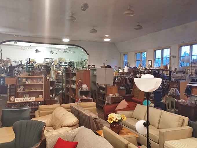 Sofas, lamps, and a "Bless This Mess" sign that honestly sums up the whole delightful situation perfectly.