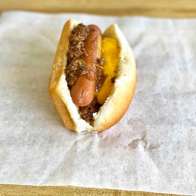 A proper chili dog, honest and unapologetic, the kind of savory bite that earns its place on any menu.