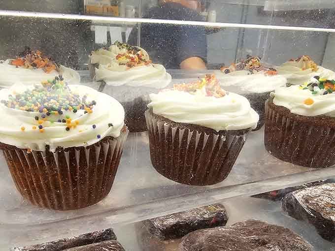 Fresh-baked cupcakes sitting right there in the display case, daring you to make responsible decisions.