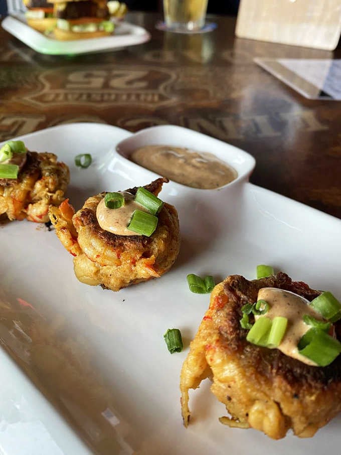 Lincoln's Roadhouse crawfish cakes arrive plated beautifully, topped with green onions and a sauce that rewards every single bite.
