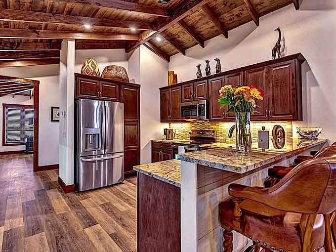 Rich wood cabinetry, granite countertops, and stainless steel appliances make this kitchen almost too beautiful to actually cook in.