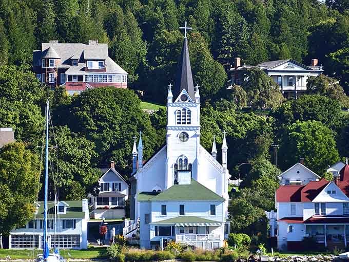 Sainte Anne's Church rises above the treeline like a postcard that Michigan has been sending for centuries.