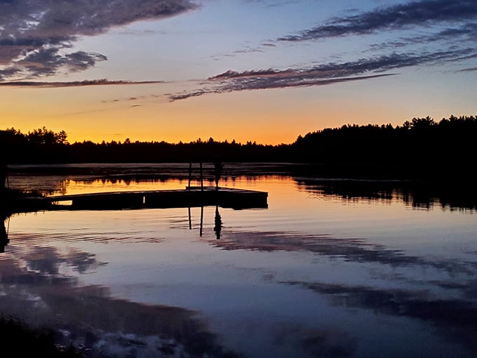 That dock silhouette against a blazing orange and purple sky is the kind of sunset that earns a standing ovation.