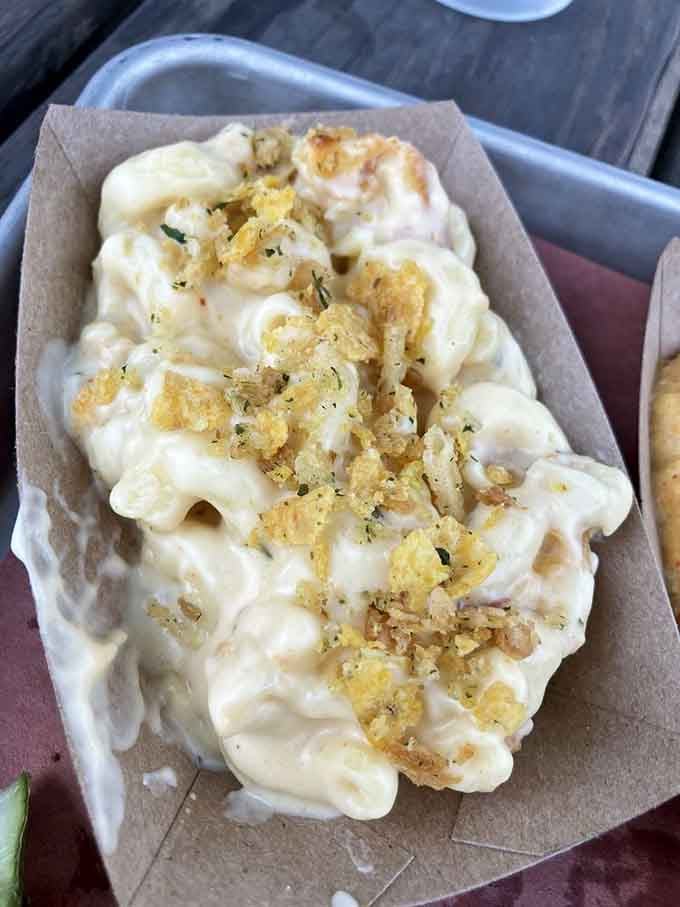 Mac and cheese topped with crispy bits is comfort food that earned its place on a barbecue menu.