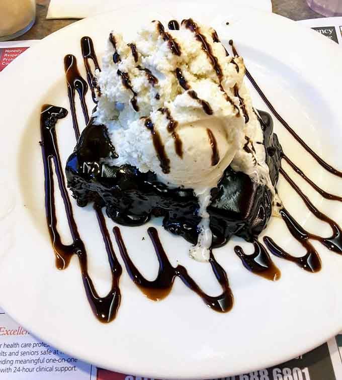 Dark chocolate brownie, vanilla ice cream, and a chocolate drizzle that looks like abstract art you can eat.