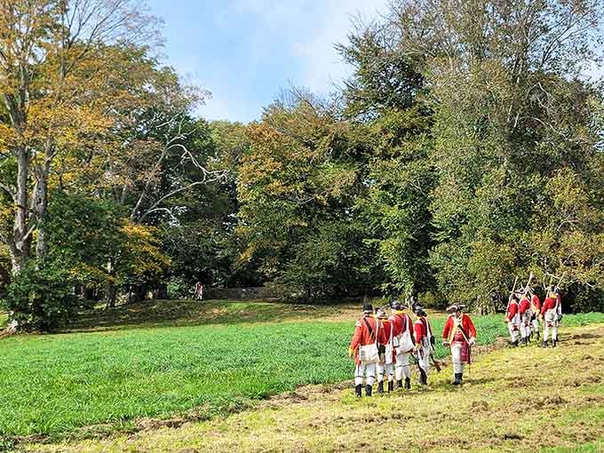 Reenactors in redcoats march through the park, bringing history to life with impressive dedication and period-accurate swagger.