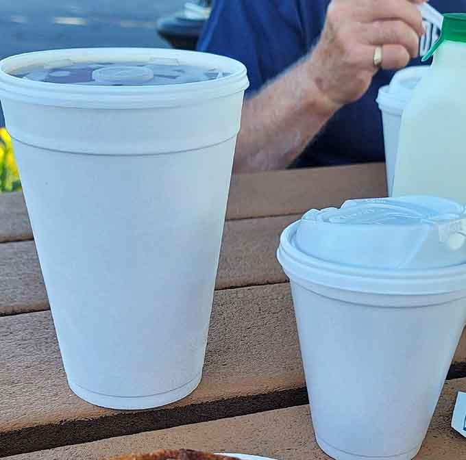 A warm drink and a sticky bun at a picnic table outside, that's what a good morning looks like.