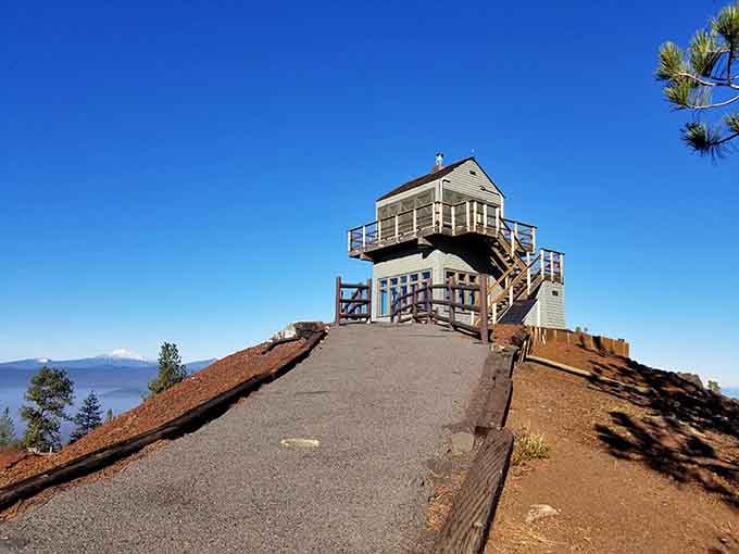 The Lava Butte fire lookout tower perched at the summit, standing watch over a landscape born from fire.