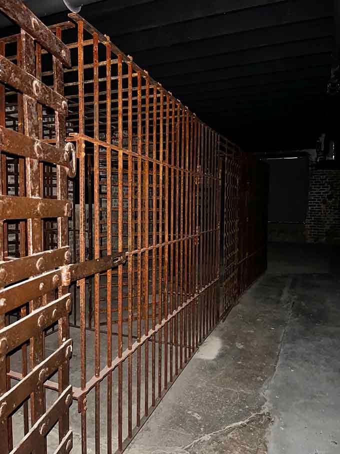 Rows of rust-covered cages stretch into the darkness. History doesn't always clean up nicely.