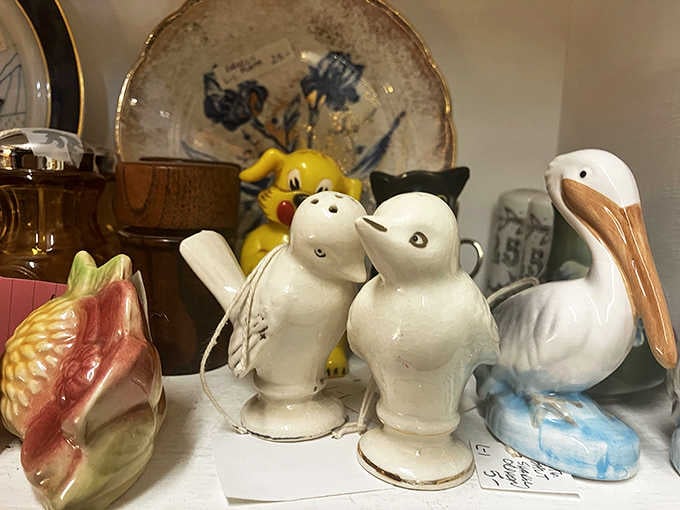 Ceramic birds, a cheerful yellow pup, and a pelican walk into a shelf, and somehow it all works perfectly.