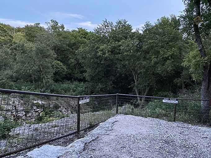 A limestone overlook with a "Quiet Please" sign, because even the rocks know the bats deserve some respect.