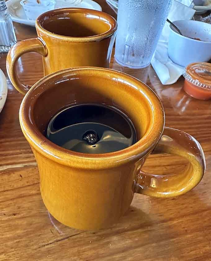 Hot coffee in classic mugs because some traditions don't need fancy upgrades to be absolutely perfect.