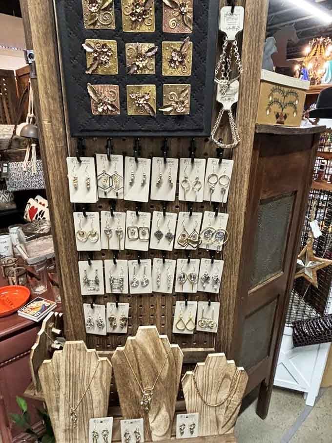 Rows of handcrafted earrings and necklaces displayed on weathered wood. Small treasures that pack a serious punch.