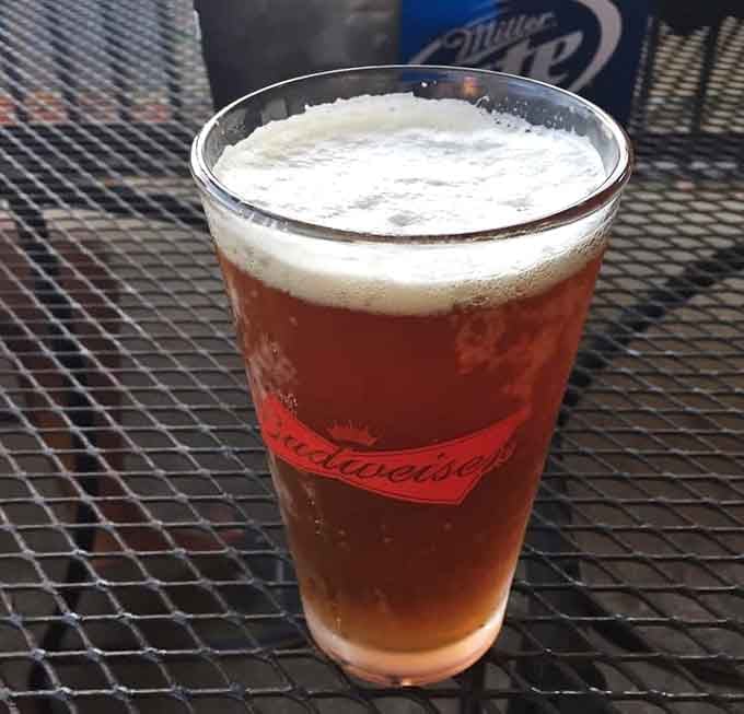 A cold, foamy beer in a Budweiser glass, the perfect companion to a basket of great fried fish.