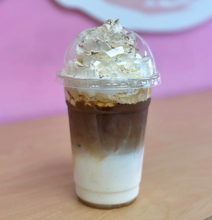 This iced pumpkin spice latte towers with whipped cream confidence, ready to make your autumn dreams reality.