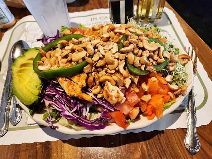 Cashews, avocado, grilled chicken, and crisp purple cabbage piled high, this salad means serious business on a very large plate.
