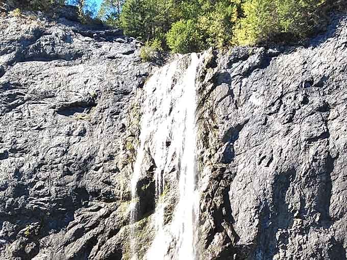 On a clear autumn day, Peewee Falls threads down the rock face like nature's own silver ribbon.