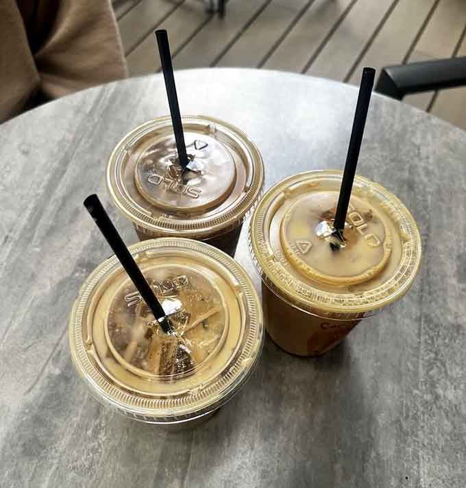 Three iced lattes on a table, proof that good things really do come in threes.