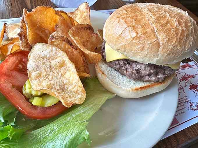 A proper cheeseburger on a toasted roll with house-made chips on the side, simple, honest, and absolutely no complaints here.