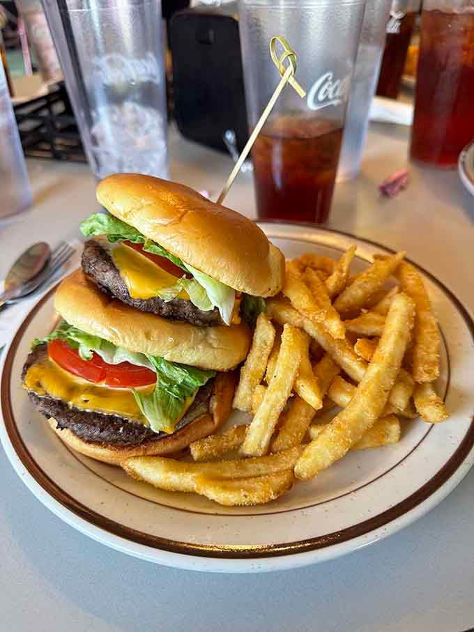 A double cheeseburger stacked tall, served with fries that earned their spot on the plate.
