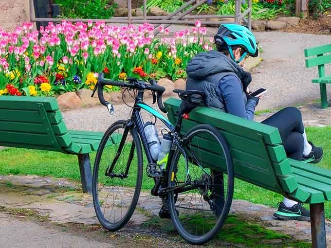 Even cyclists stop here, lean their bikes against a green bench, and just sit quietly among the tulips for a while.