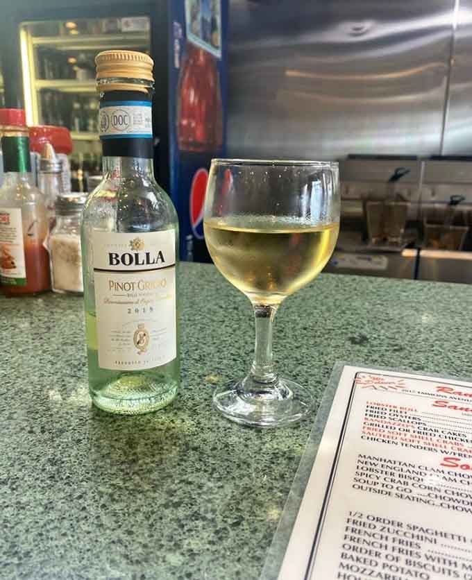 A chilled glass of Pinot Grigio beside the menu is the universe gently suggesting you slow down and enjoy this.
