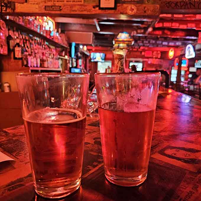 Two cold pints glowing red in the bar light. The first legal drinks in Texas history tasted something like this.
