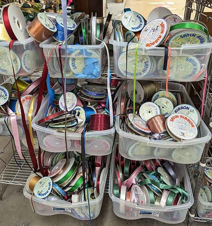 Bins overflowing with satin ribbon spools, a colorful tangle of possibilities just waiting to be untangled.