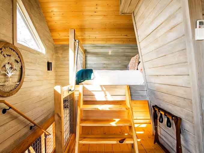 A lofted sleeping nook reached by wooden stairs. Your childhood self is absolutely losing its mind right now.