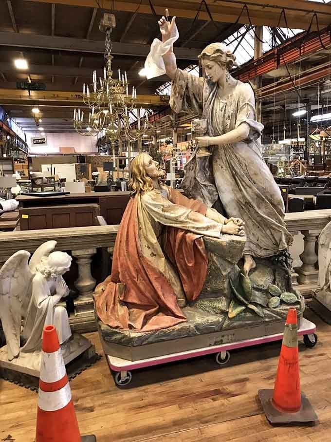 Not every thrift store has large religious statues standing quietly between the chandeliers and the dining chairs. This one does.