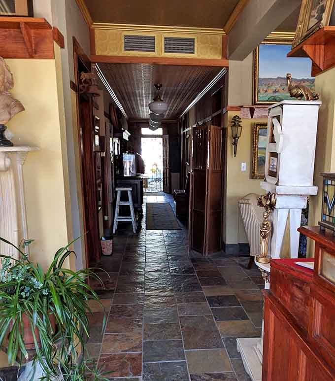 A hallway lined with art, sculpture, and warm golden walls that somehow makes you feel like you've always belonged here.