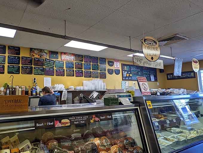Chalkboard menus stretching wall to wall, a cheerful staff behind the counter, and a "Order Here" sign pointing you toward happiness.