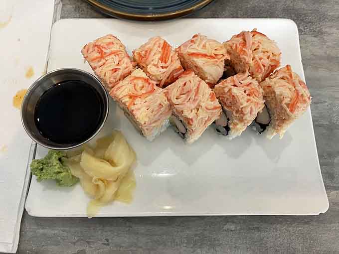 The Double Crab Roll arrives clean and confident, served with soy sauce, pickled ginger, and a touch of wasabi.