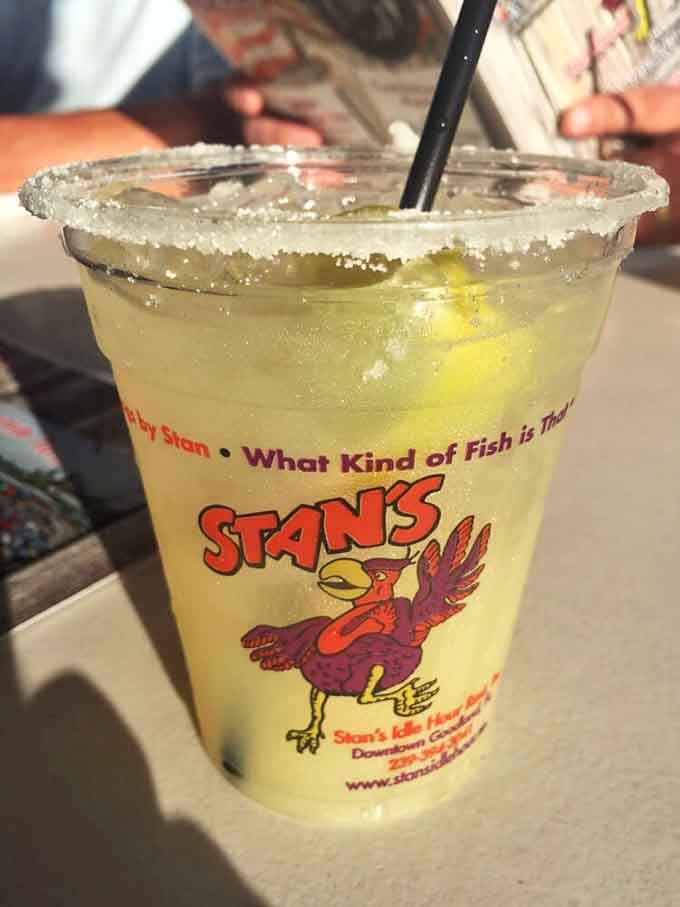 Stan's signature margarita in a branded cup, salt-rimmed and ice-cold. The cup alone tells you this place has serious personality.