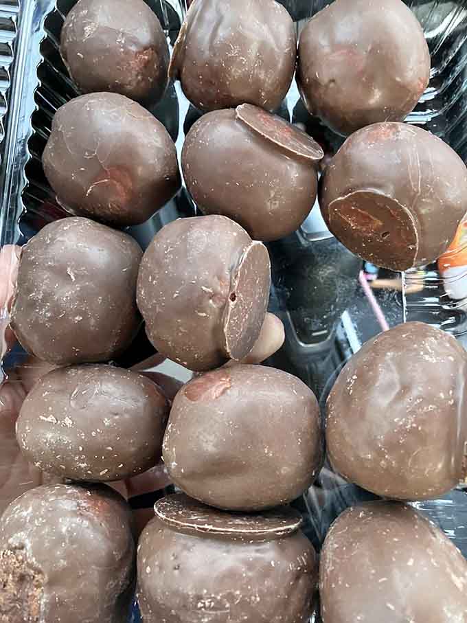 Chocolate-coated donut holes stacked like edible treasure. One is never, ever going to be enough. Plan accordingly.