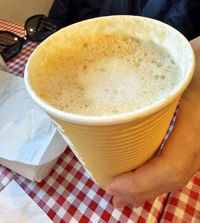 A proper latte in a paper cup proves that great coffee doesn't need fancy china to taste like heaven.