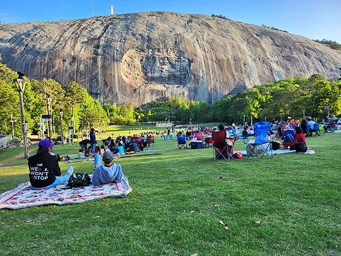 Families gather on the lawn for the legendary laser show, because nothing says Georgia like projecting lights on granite.